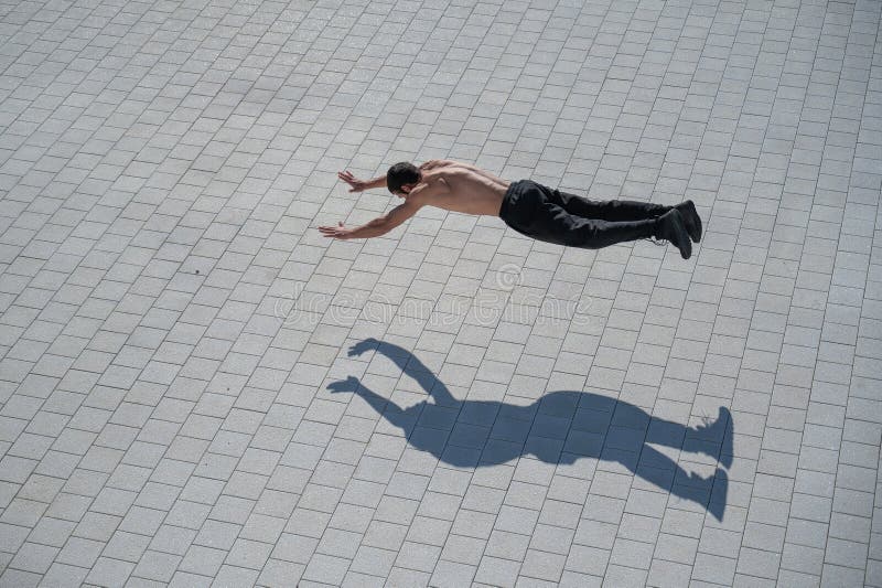 A Man Doing Push-ups with Flying Outdoors. Stock Photo - Image of ...