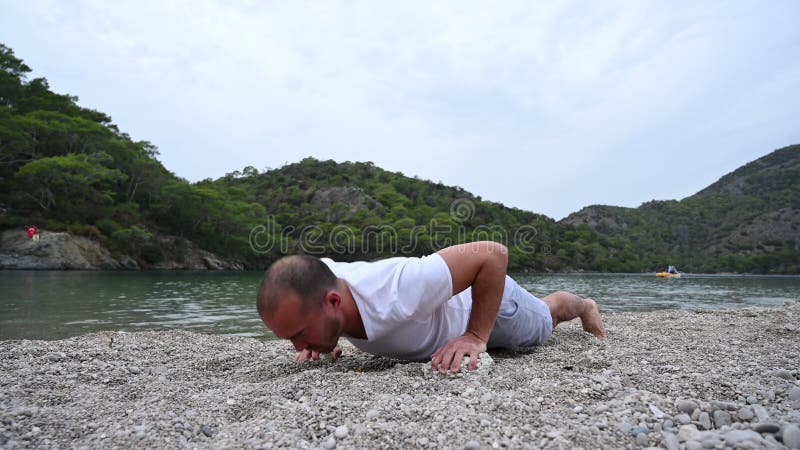 Man Doing Push Ups on Pebble Beach Stock Video - Video of pebble ...