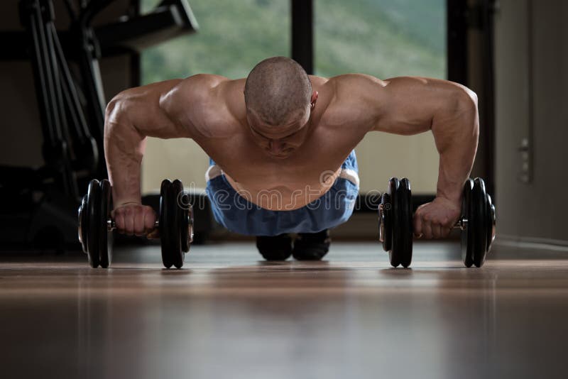 Man Doing Pushups on Dumbbells Stock Image - Image of active, cross ...