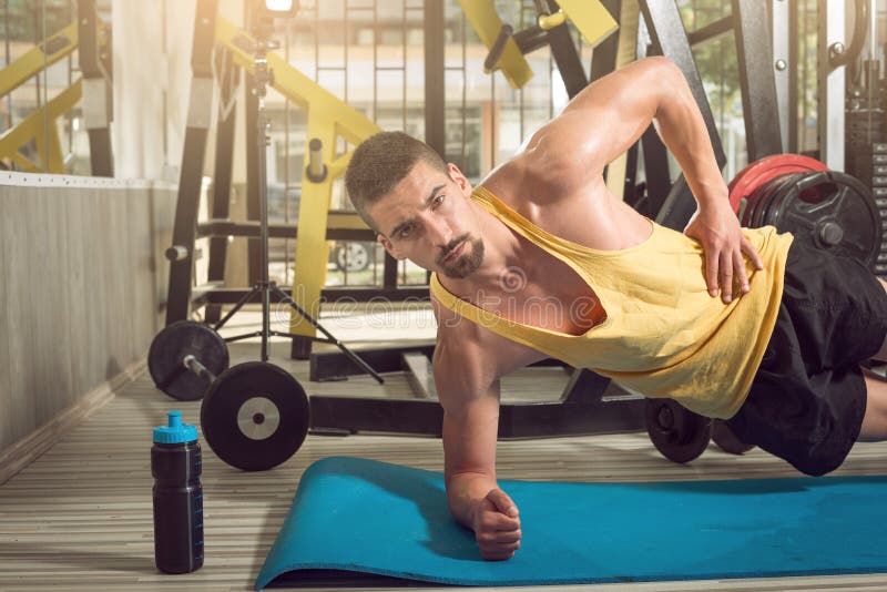 Man Doing Side Plank Exercise in Gym Stock Image - Image of human ...
