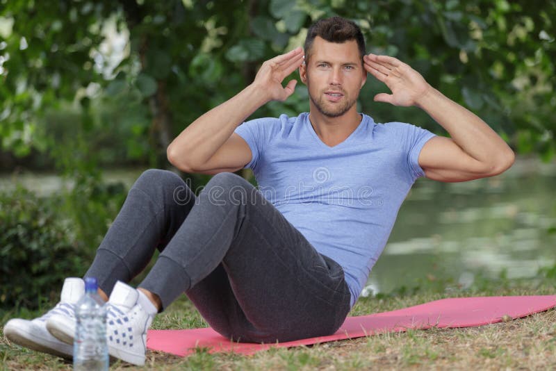 Man doing sit ups outdoors stock photo. Image of athletic - 164148690