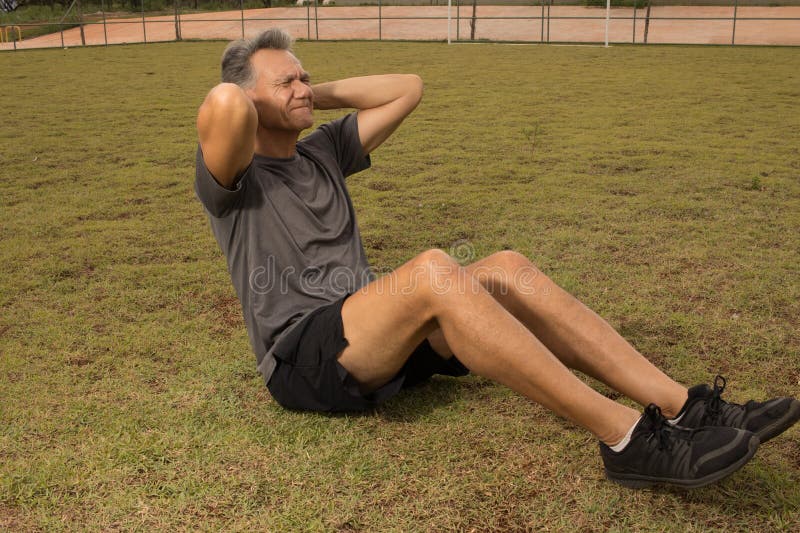 Man doing sit ups outside stock photo. Image of wellness - 270216168