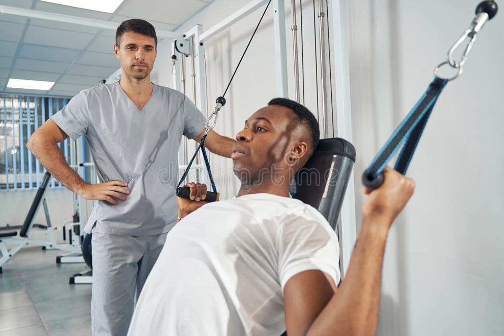 Man Doing Strength Training Exercise Using Gym Equipment Stock Photo ...