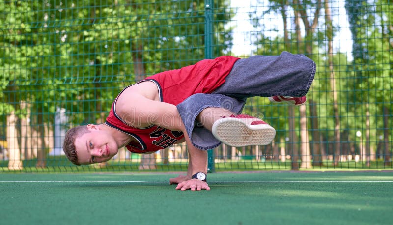 B-boy Doing Stunt Trick on Basketball Field with Ball Stock Image ...