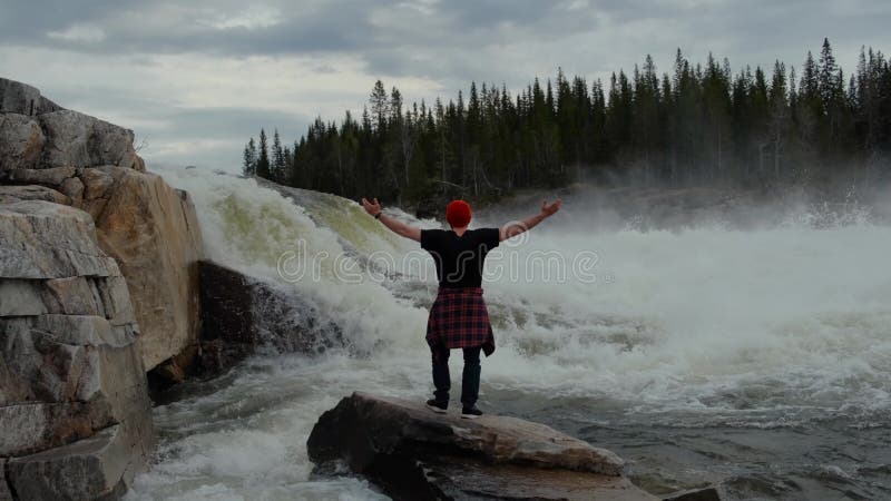 Man Doing Success Pose Outside in Front of Waterfall Stock Video ...