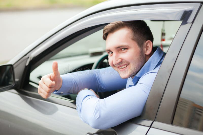 Man doing thumbs up in car stock photo. Image of road - 65915552