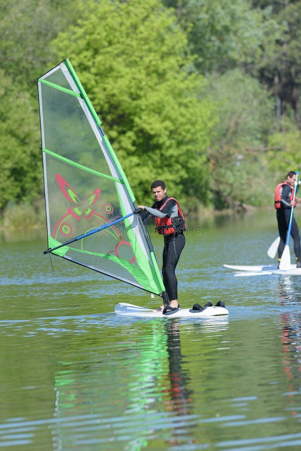 Man doing wind surfing stock photo. Image of sail, water - 234075764