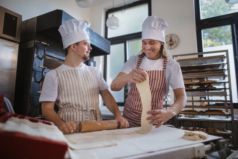 Man with Down Syndrom Helping Prepair Bread in Bakery with His ...