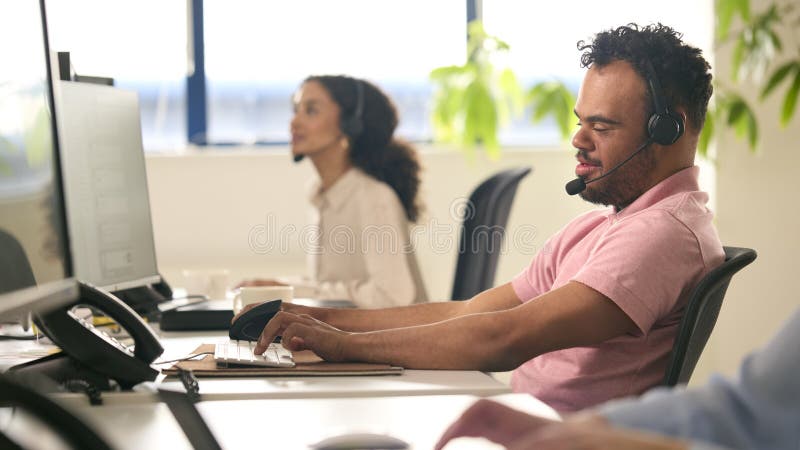 Man with Down Syndrome Wearing Headset Working in Office Call Centre ...