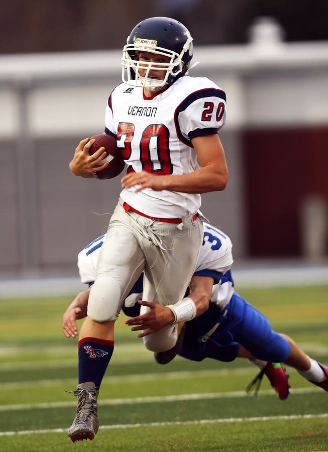 Man Dragging Down The Opponent Holding The Football Running On The ...