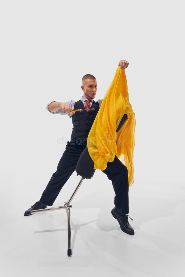 Man Dramatically Interacts with Yellow Fabric and Black Mannequin ...