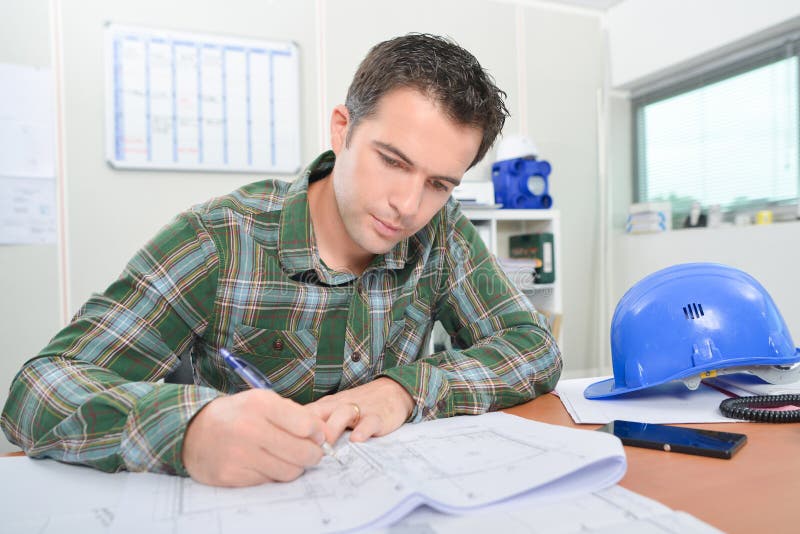 Man drawing a blueprint stock image. Image of indoors - 116229205