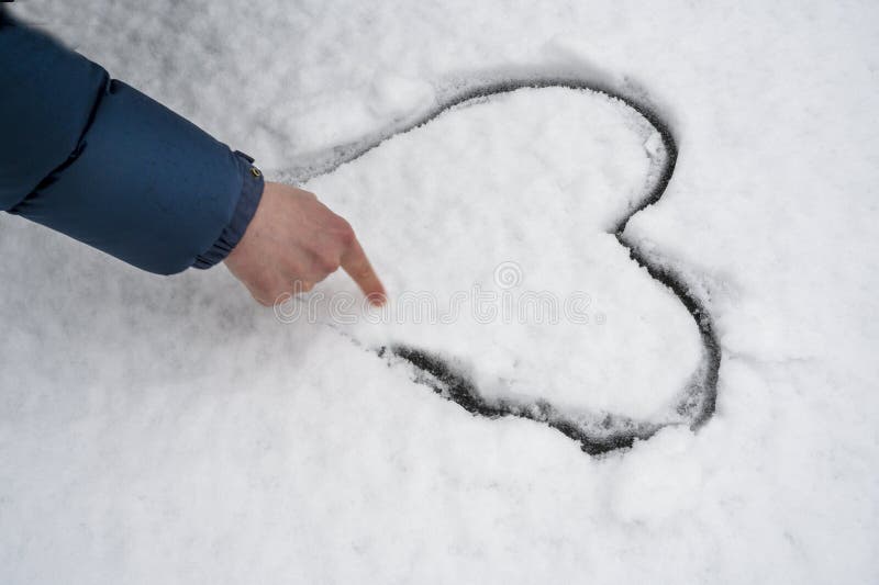 Man Drawing Heart Shape on Snow in Winter. Cold Heart Stock Photo ...
