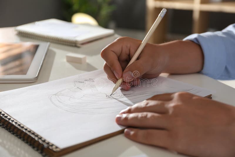 Man Drawing Portrait with Pencil in Notepad at Table Stock Image ...