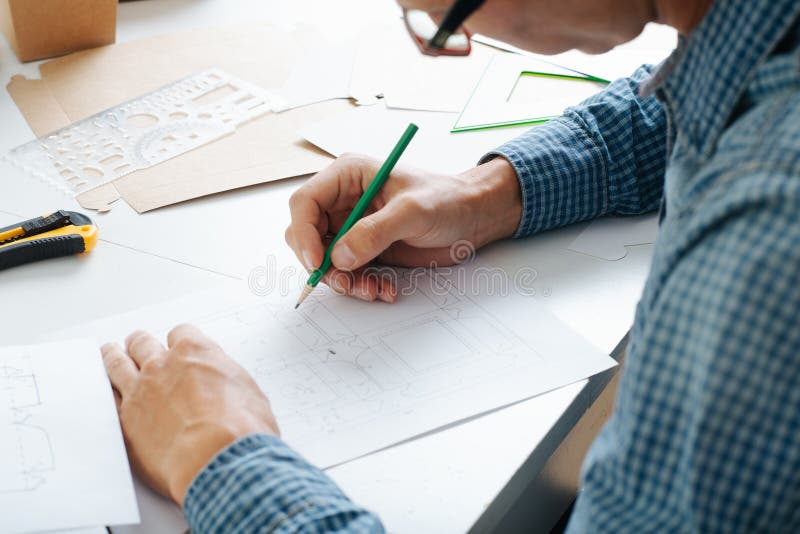 Man Drawing Scematics for Production of Boxes. Close Up. from Behind ...