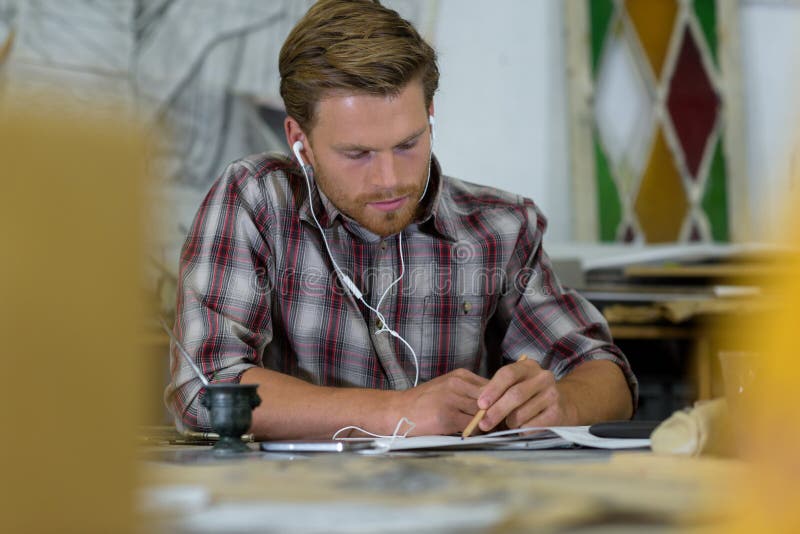 Man drawing in studio stock image. Image of graphic - 158695525