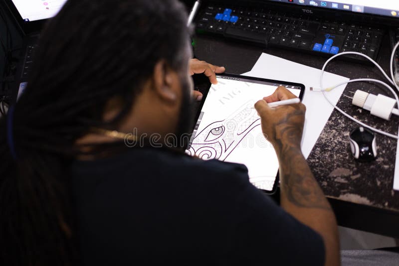 Man Drawing on a Tablet. Rear View. Selective Focus. Stock Photo ...