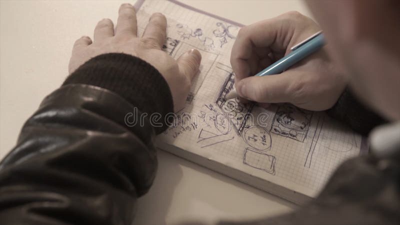The Man Draws in a Notebook,taking Notes, the Person Writes in a Diary ...