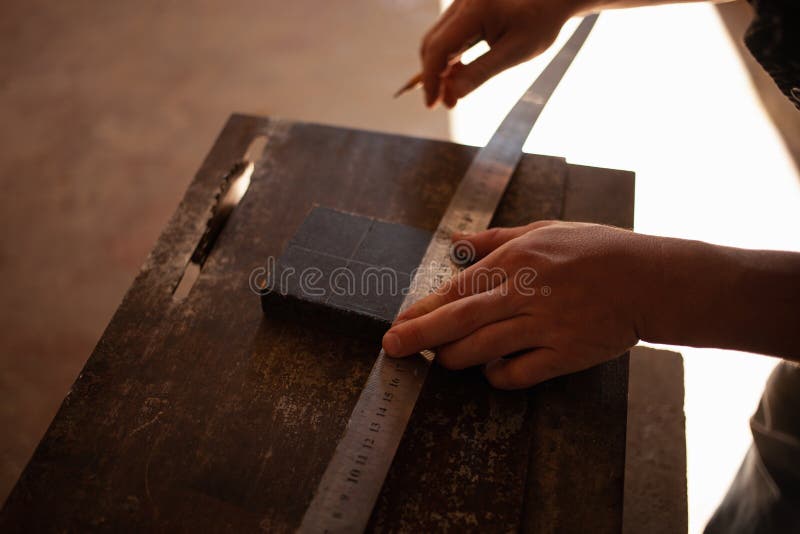 The Man Draws a Pencil and a Ruler on a Piece of Wood for Sawing Stock ...