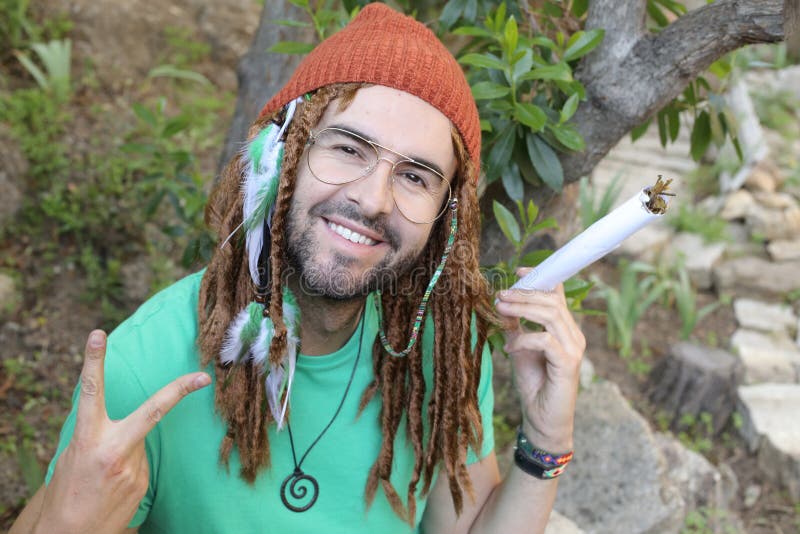 Man with Dreadlocks Smoking a Very Large Cigarette Stock Image - Image ...