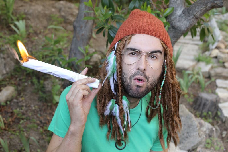 Man with Dreadlocks Smoking a Very Large Cigarette Stock Image - Image ...