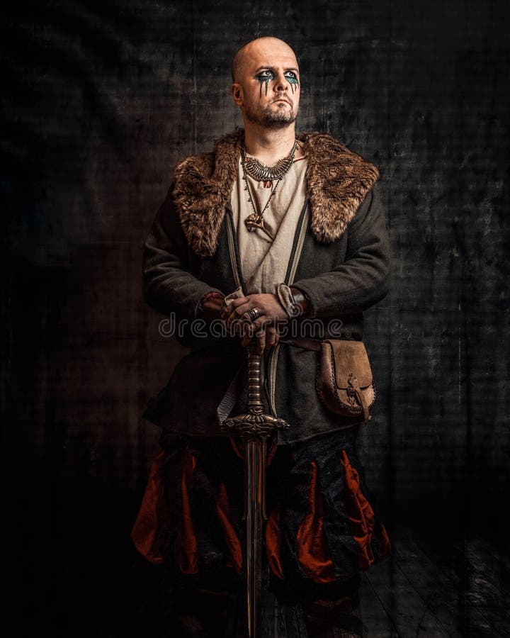 Man Dressed in Authentic Medieval Armor Sitting Against Dark Background ...