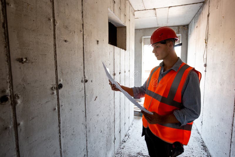Man Dressed in Orange Work Vest and Helmet Explores Construction ...