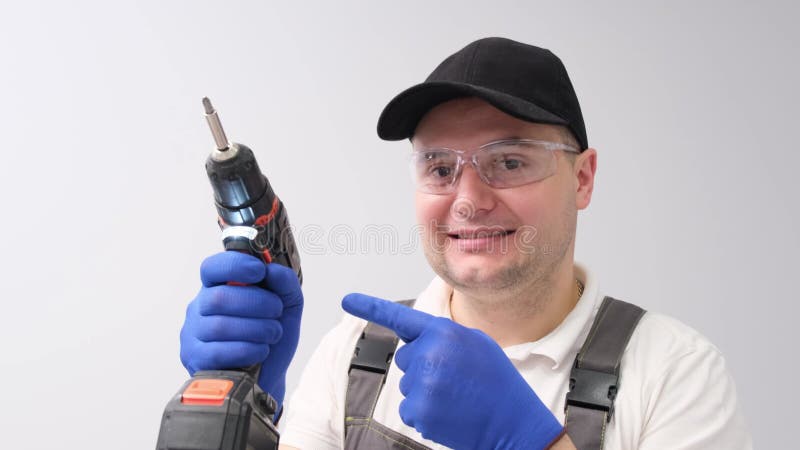 A Man with a Drill. Electric Drill for Internal Repair. Electric ...