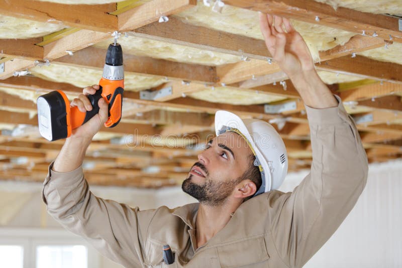 Man drilling ceiling stock image. Image of electric - 268742469