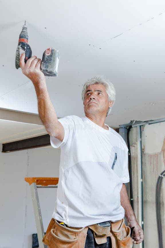 Man drilling ceiling stock image. Image of worker, handyman - 298846841