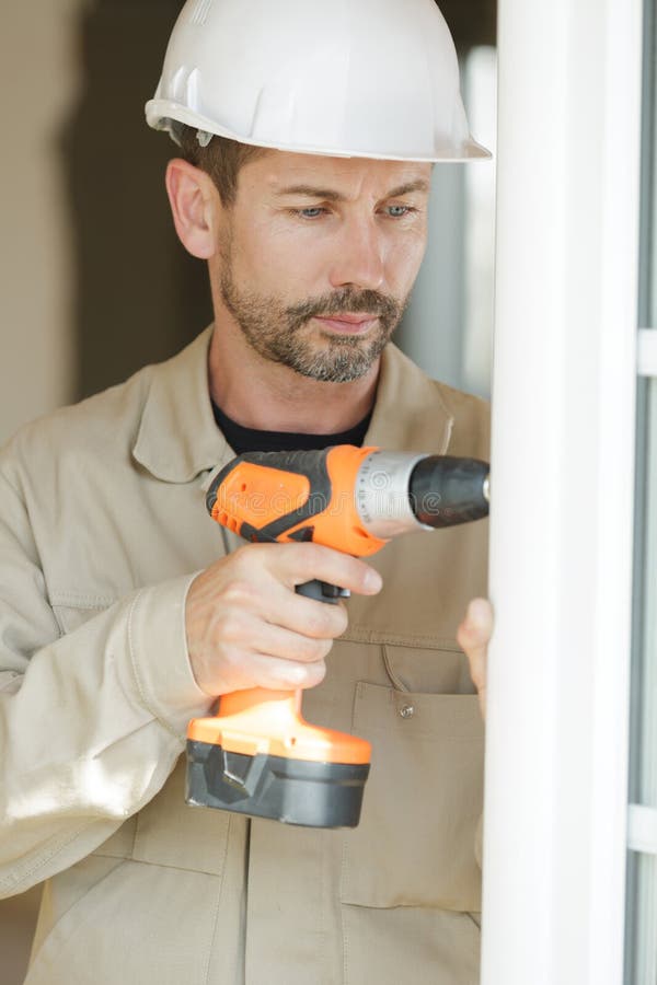 Man Drilling Hole in Window Frame Stock Photo - Image of construction ...