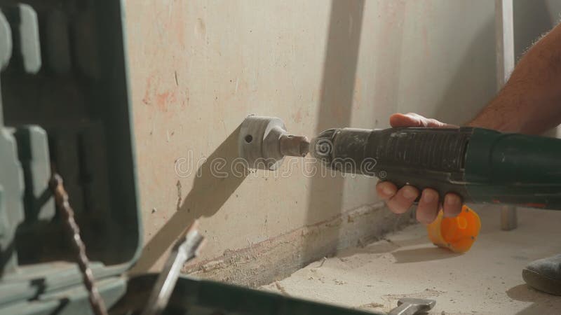 Man Drilling Round Hole in Concrete Wall for Socket. Builder Drills ...