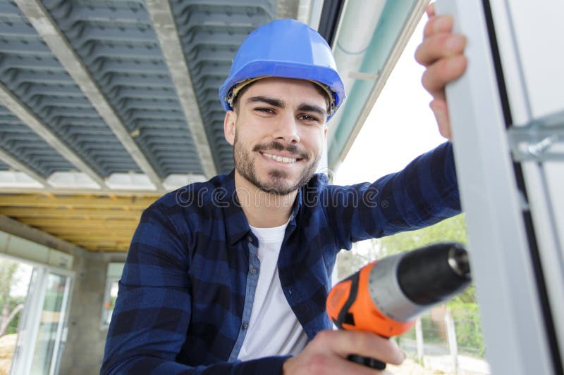 Man drilling window frame stock image. Image of operate - 321921661
