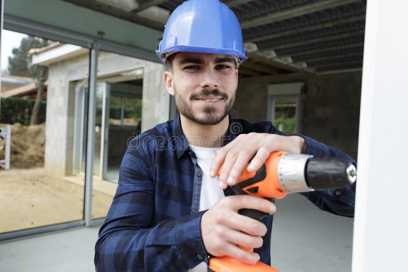 Man drills wall with drill stock image. Image of interior - 302959433