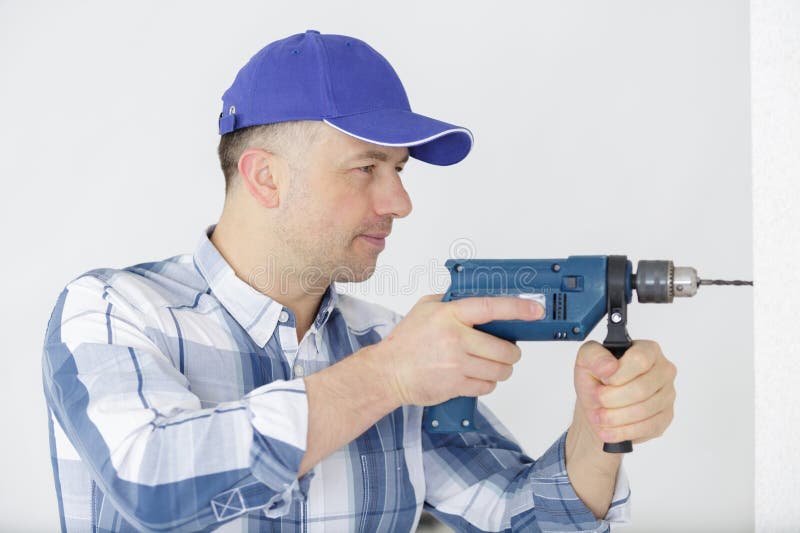 Man drills wall with drill stock image. Image of male - 270839559