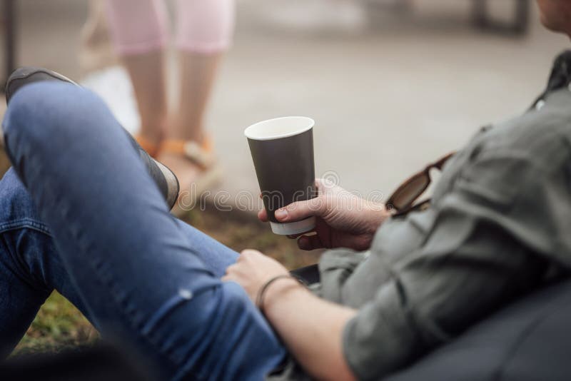 Man Drinking Beer from Biodegradable Cup while Sitting on a Bench Stock ...