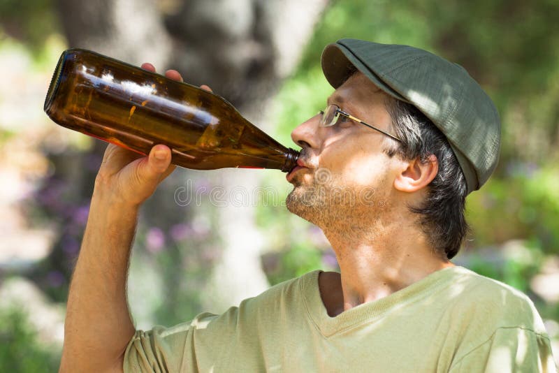 Man Drinking Beer from Bottle Stock Image - Image of outdoor, outdoors ...