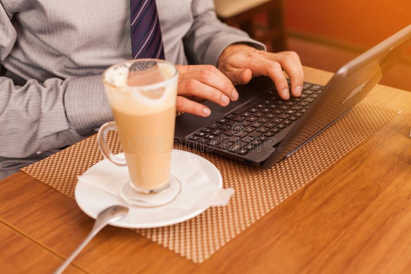 Man Drinking Coffee in Cafe and Using Laptop Stock Photo - Image of ...