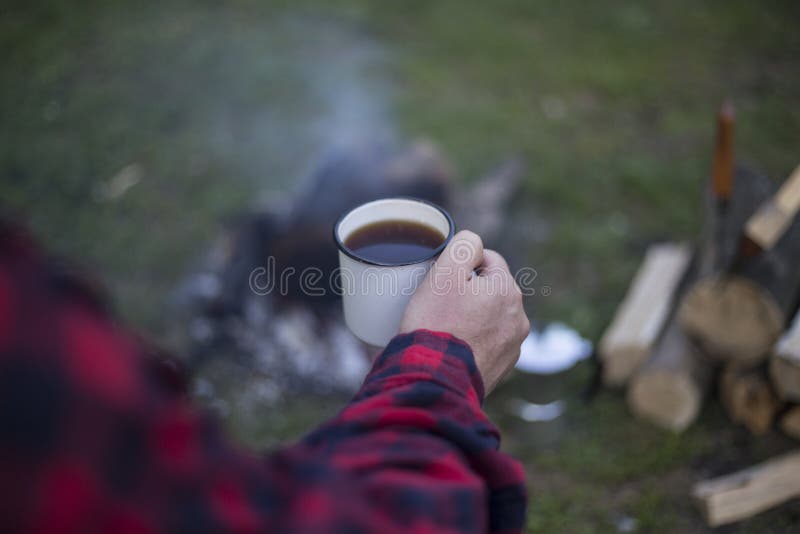 Man Drinking Coffee by the Fire. Stock Photo - Image of compass, dishes ...