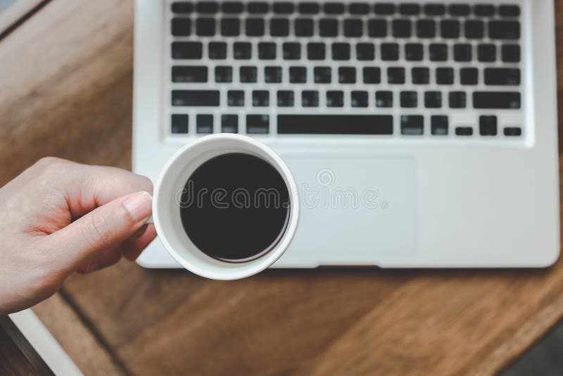 Man Drinking Coffee at Coffee Shop and Working on Laptop Stock Image ...