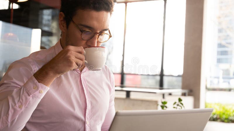 Man Drinking Coffee in a Terrace while Working on Computer Stock Photo ...