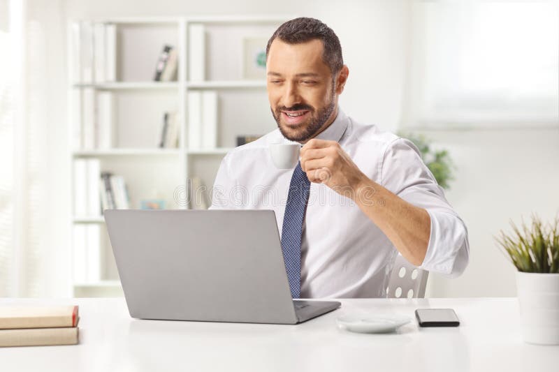 Man Drinking Coffee and Working at a Laptop Computer Stock Photo ...