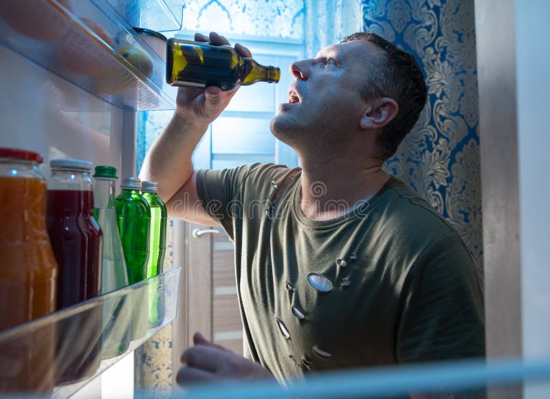 Man Drinking a Cold Bottle of Beer from His Fridge Stock Image - Image ...