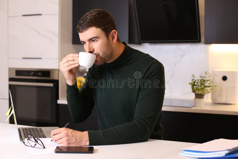 Man Drinking a Cup of Coffee while Working from Home Stock Photo ...