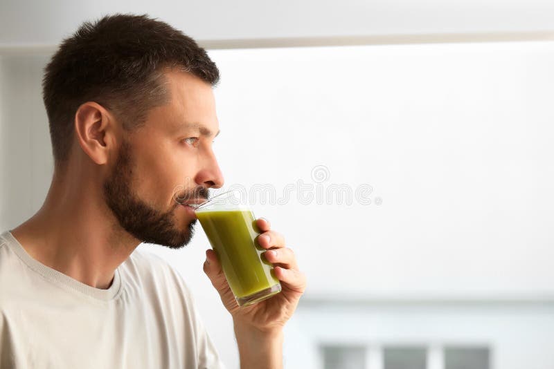 Man Drinking Delicious Juice Indoors, Space for Text Stock Image ...