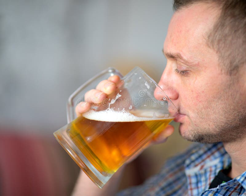 The Man is Drinking a Fresh, Cold Beer from a Large Mug Stock Image ...