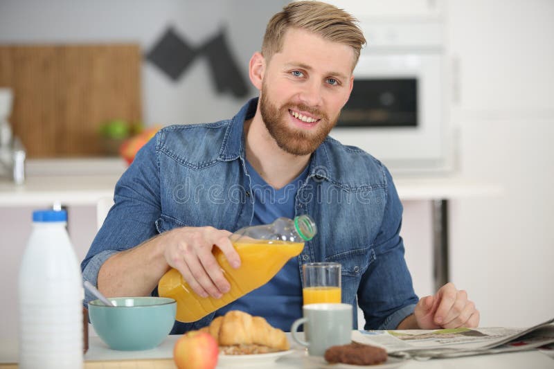 Man Drinking Juice Sitting on Couch at Home Stock Image - Image of ...