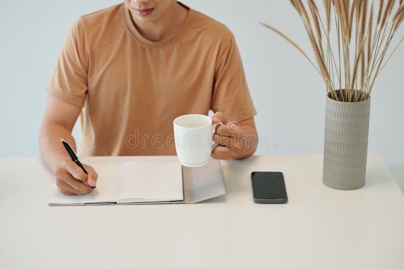 Man Writing in Planner stock photo. Image of journal - 271334530