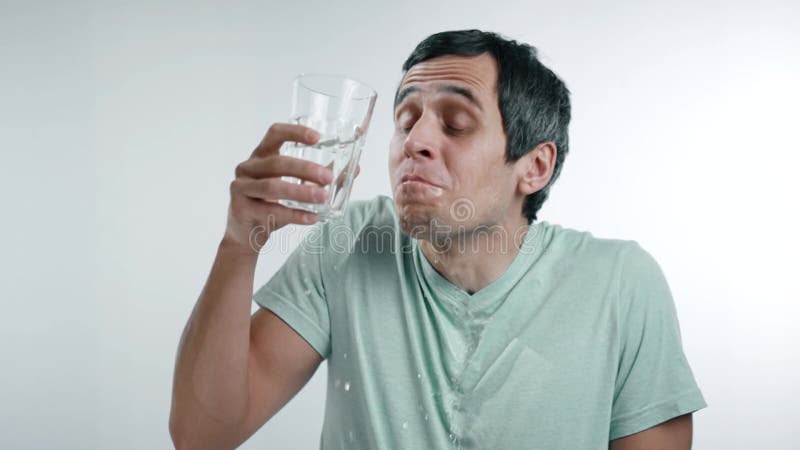 Man Drinking Water and Accidentally Spilling it on Himself Stock Video ...