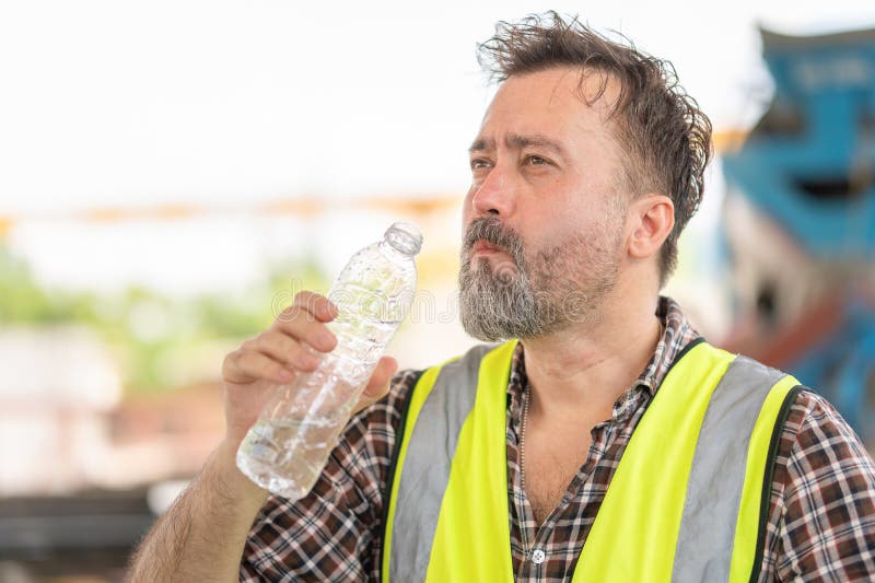 Man Drinking Water at the Precast Factory Site, Engineer Man Drinking ...